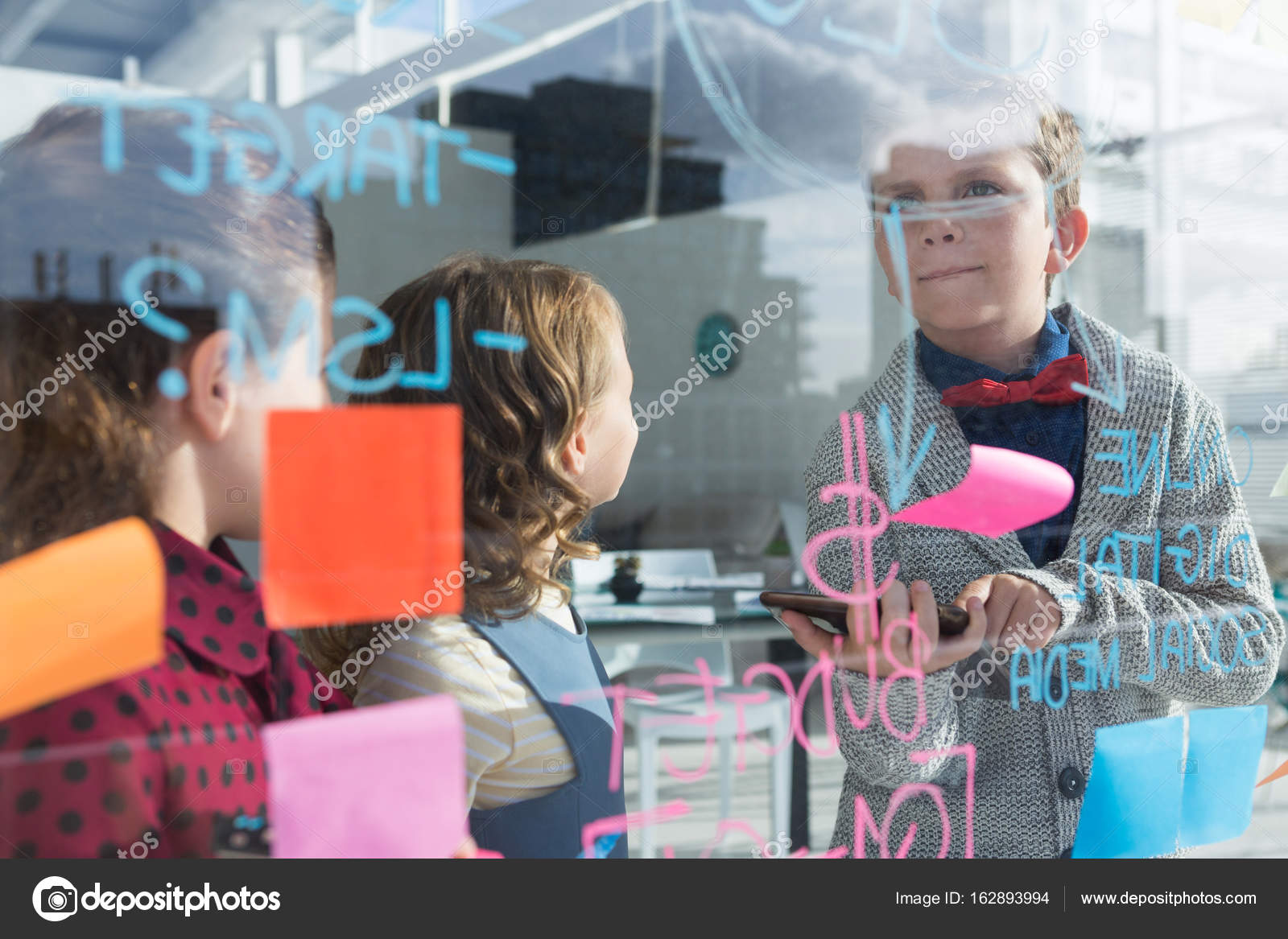 Kids analyzing data on window Stock Photo by ©Wavebreakmedia 162893994