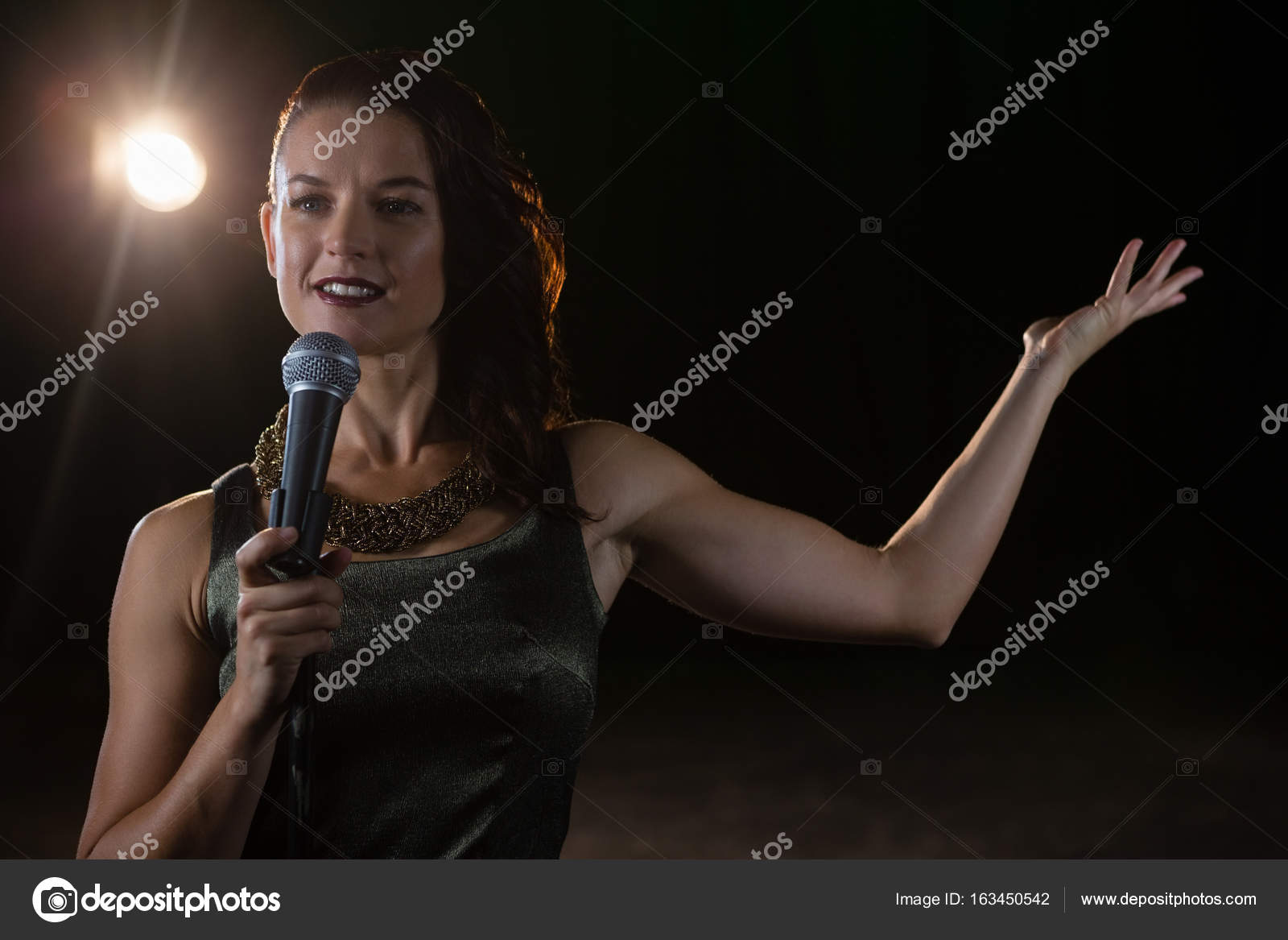 Female singer singing into a microphone Stock Photo by ©Wavebreakmedia ...