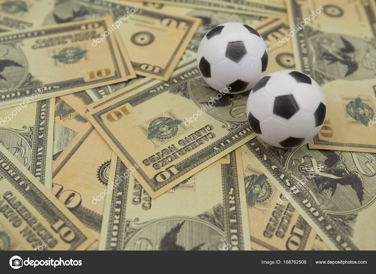Footballs on a currency notes Stock Photo by ©Wavebreakmedia 168762508
