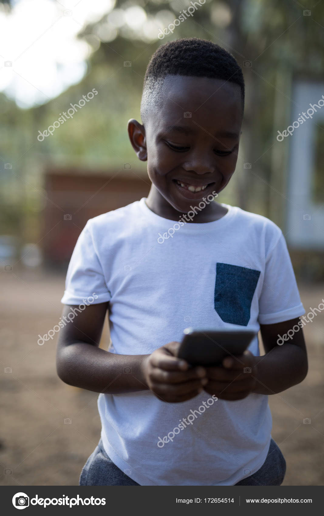 Cute boy using mobile phone Stock Photo by ©Wavebreakmedia 172654514