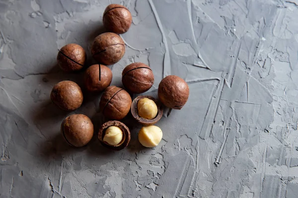 Pile macadamia nuts open kernels and shells on white background, top ...