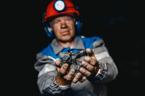 Miner angry man screams and frowns, holds sheet of paper for text ...