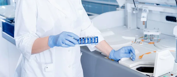 Laboratory technician sets test sample in automatic express tester ...
