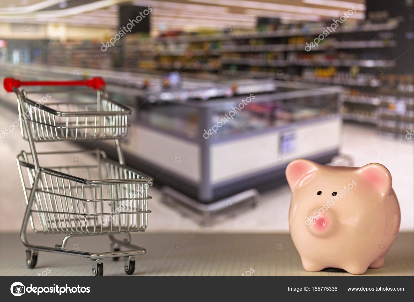 Pink piggy bank pig standing near mini shopping push cart with ...