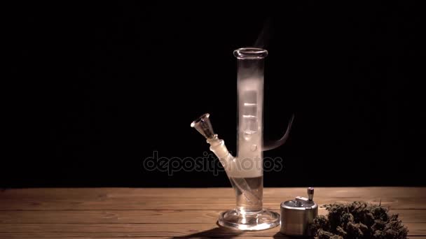 Smoking bong with marijuana on a black background — Stock Video ...