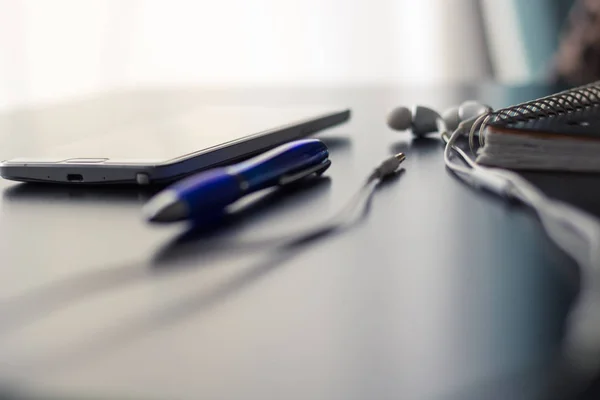 Office supplies are set on a shiny and reflective office desk. The ...