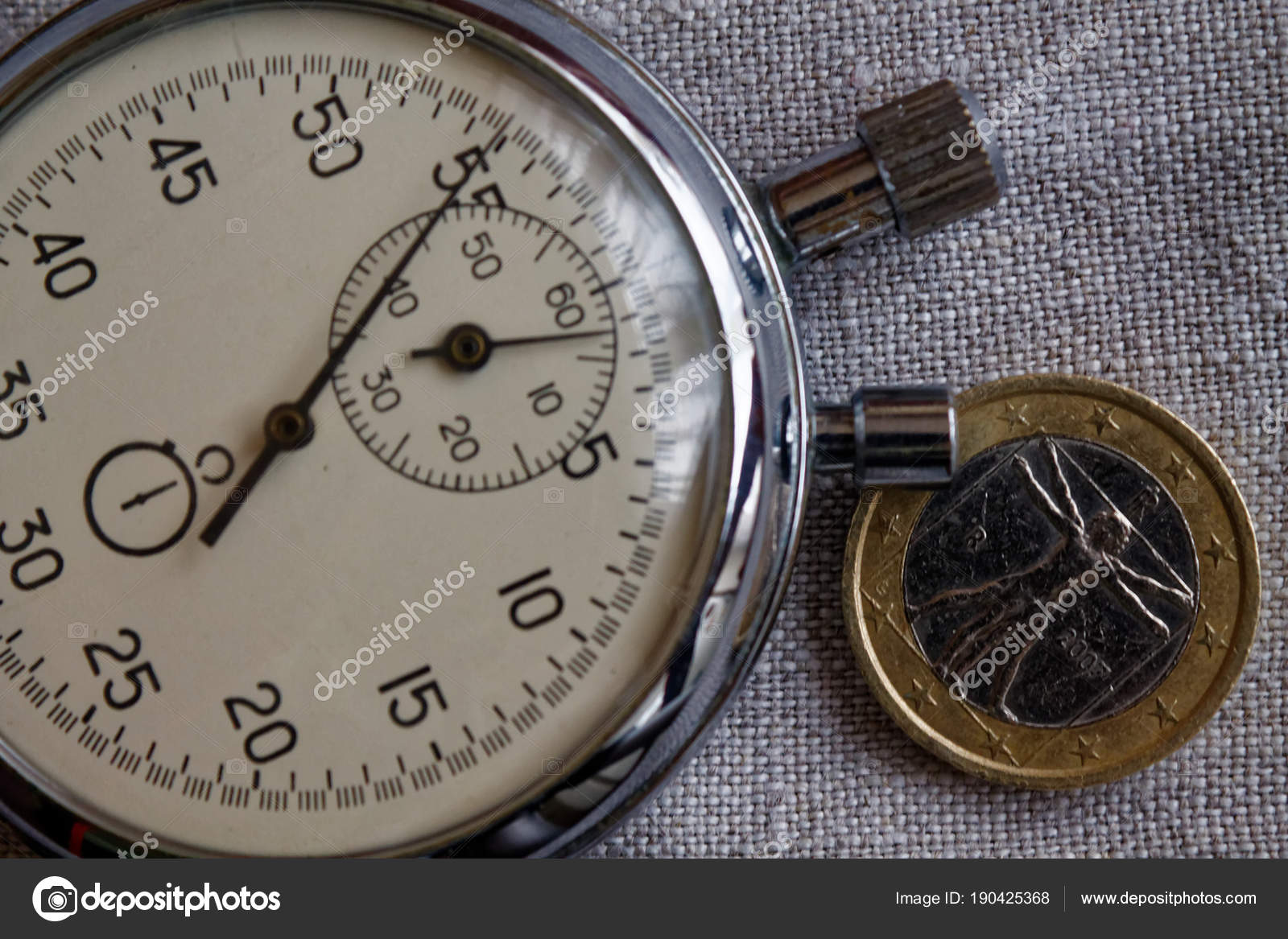 Euro coin with a denomination of one euro (back side) and stopwatch on ...