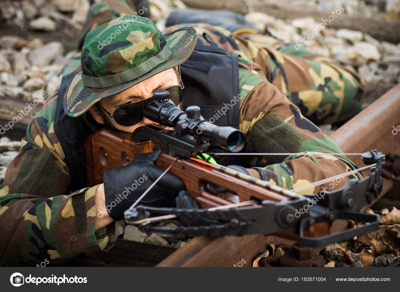 Military man aiming with crossbow Stock Photo by ©gyurma 183571004
