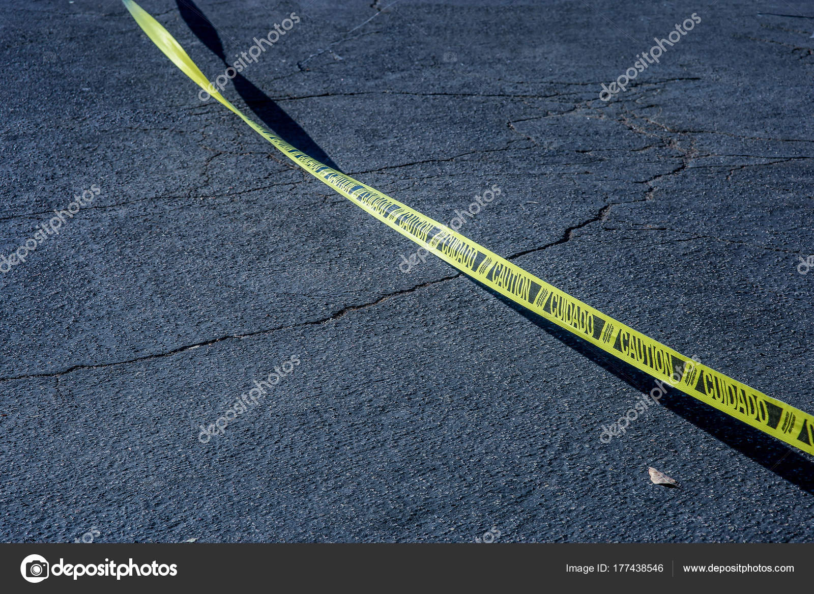 Caution tape in spanish. Yellow tape marked caution in English and ...