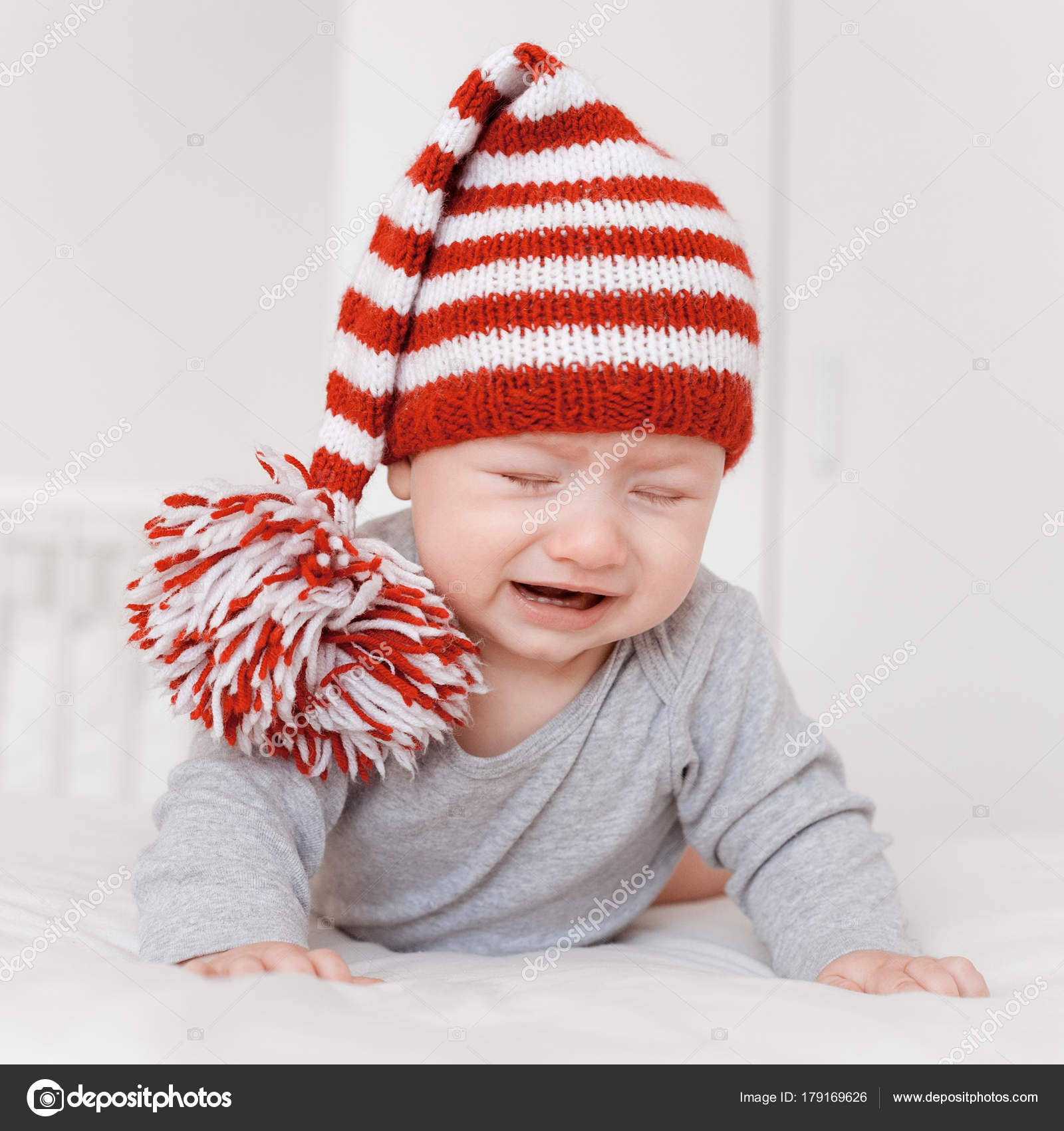 Portrait Little Crying Infant Child Funny Knitted Hat Lying Bed — Stock ... Portrait Little Crying Infant Child Funny Knitted Hat Lying Bed — Stock ...