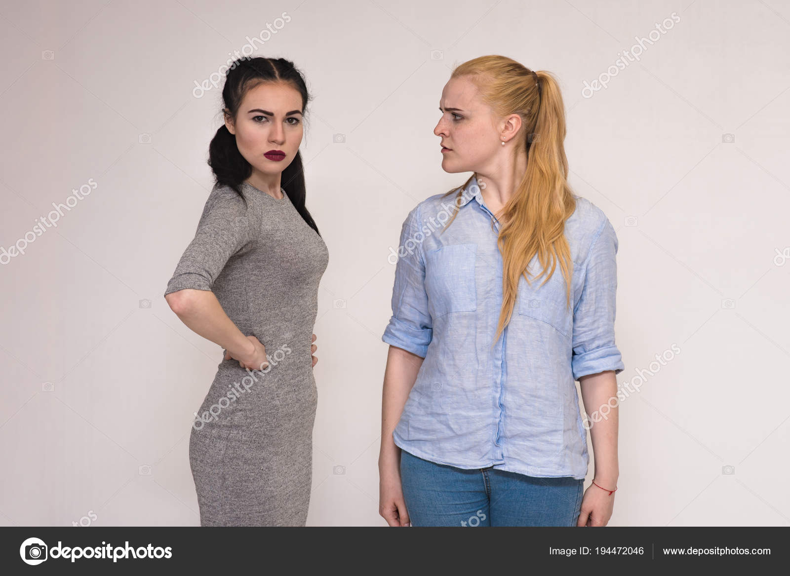 Portraits on the gray background of two girls girlfriends showing ...