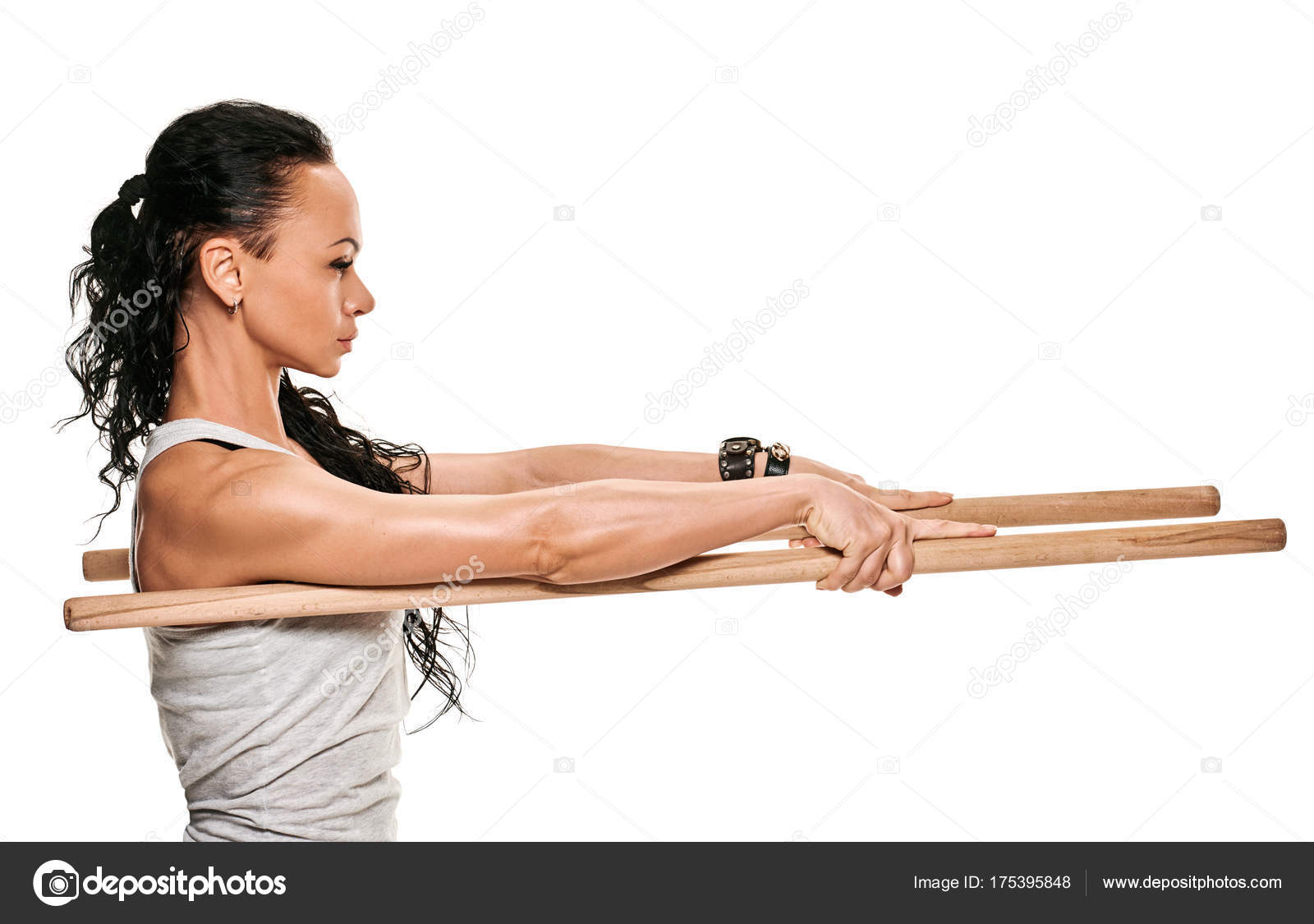 Muscular woman with sticks Stock Photo by ©seenaad 175395848