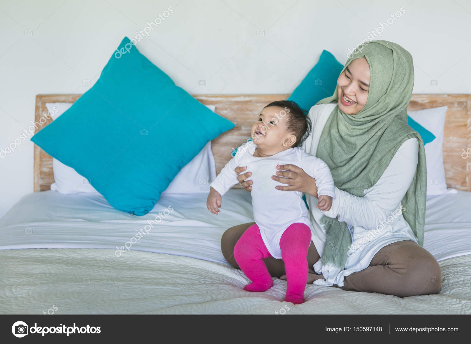 Mother helping baby take steps Stock Photo by ©odua 150597148