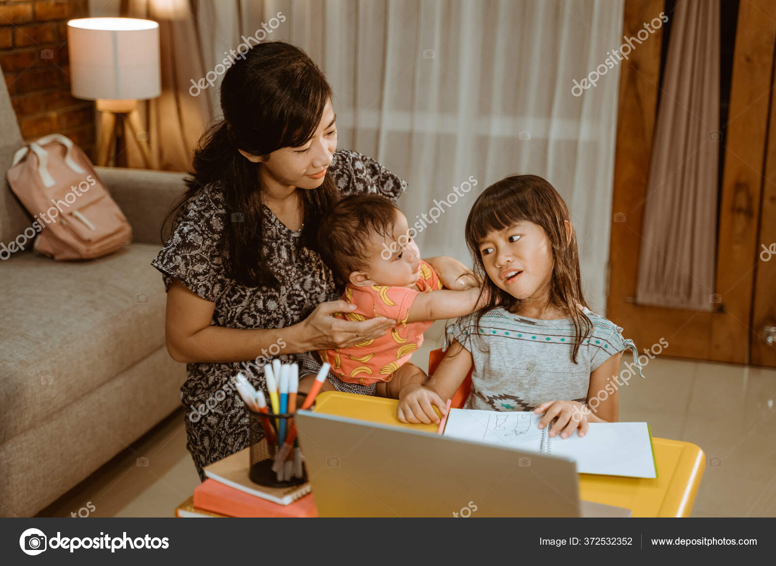 Child studying at home in the evening Stock Photo by ©odua 372532352