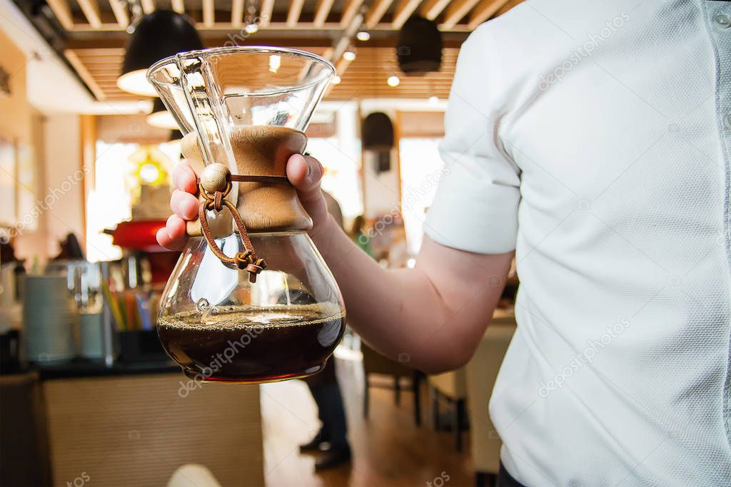 máquina para café hecho a mano de vidrio y frascos con café y una mano ...