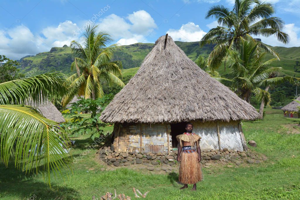 Indigenous Fijian man dressed in traditional Fijian costume, sta ...