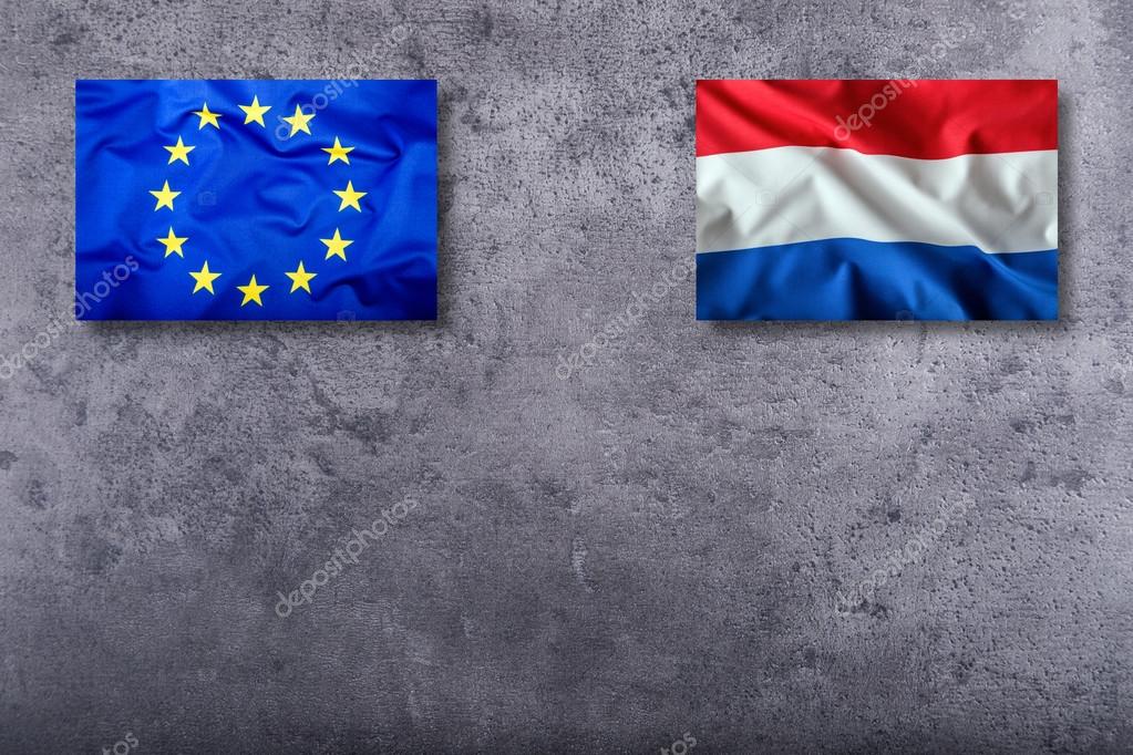 Flags of the Netherlands and the European Union on concrete background ...