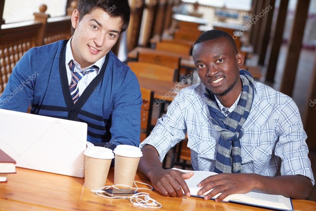 Two students looking at camera and smiling Stock Photo by ©pressmaster ...