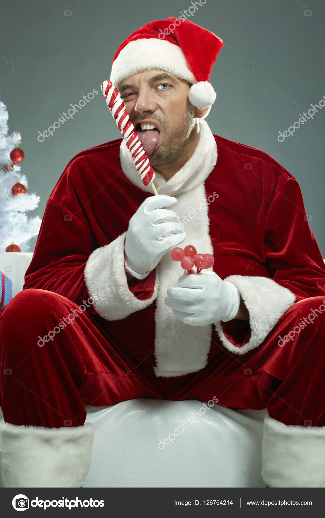 Wicked Santa sucking lollipop Stock Photo by ©pressmaster 126764214