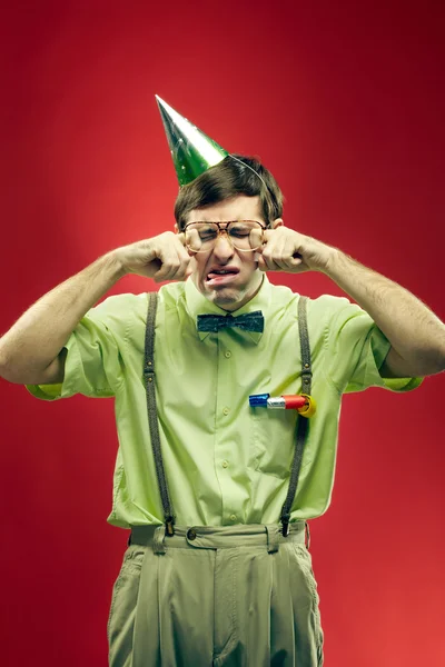 Crying childish nerd rubbing his eyes - Stock Image - Everypixel