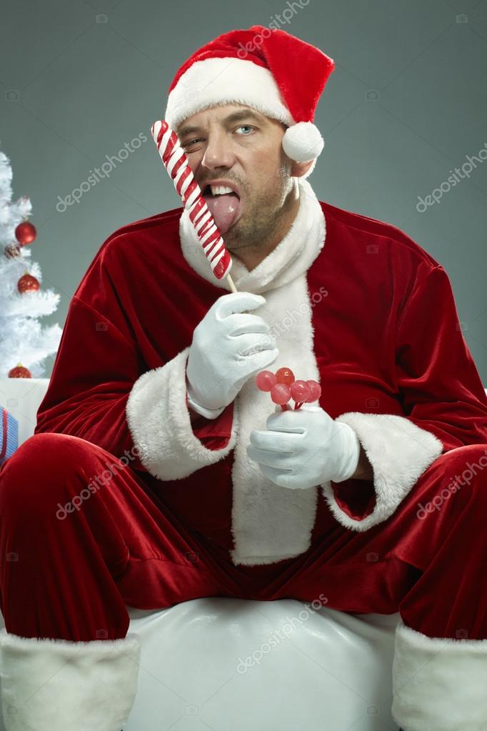 Wicked Santa sucking lollipop Stock Photo by ©pressmaster 126764214