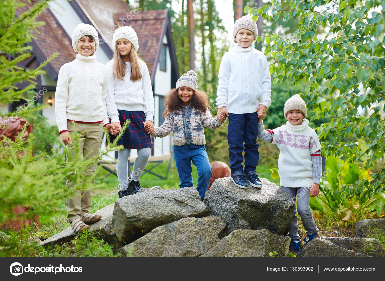 Happy kids standing on stones Stock Photo by ©pressmaster 130593902