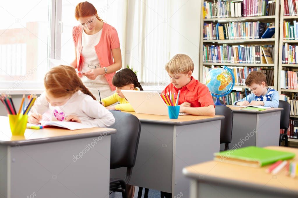 School kids busy with schoolwork — Stock Photo © pressmaster #130590094
