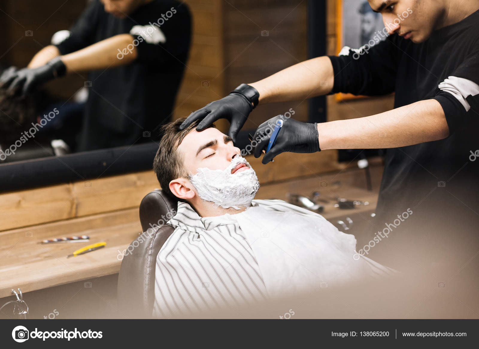Barber shaving beard — Stock Photo © pressmaster #138065200 Barber shaving beard — Stock Photo © pressmaster #138065200
