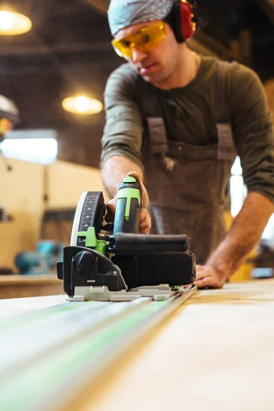 Man working with scroll-saw - Stock Image - Everypixel