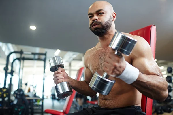 Young man sweating while exercising with dumbbells - Stock Image ...