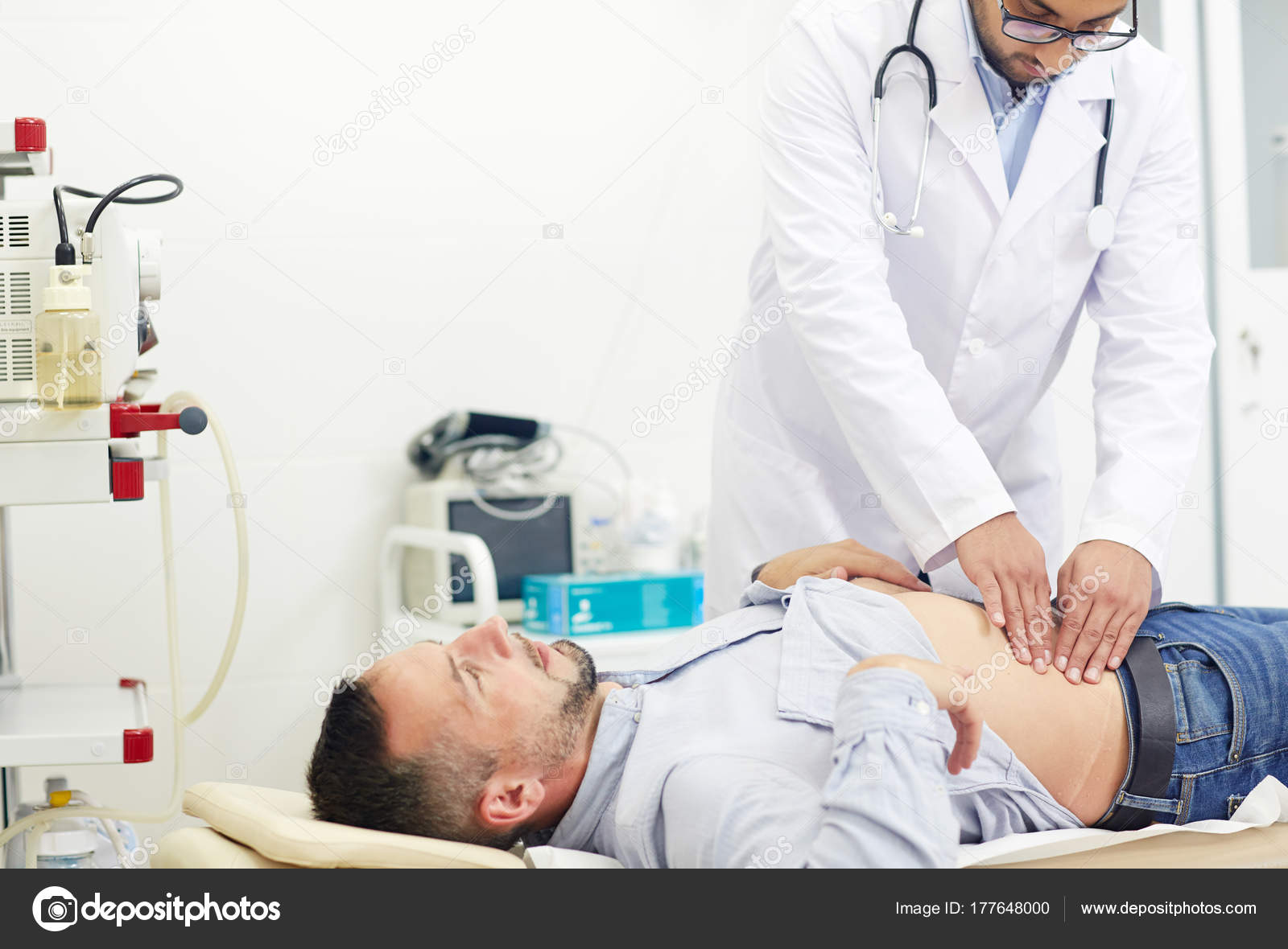 Concentrated Young Physician Doing Abdominal Palpation Middle Aged ...