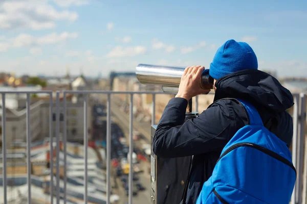 Back view portrait of contemporary tourist looking over city from ...