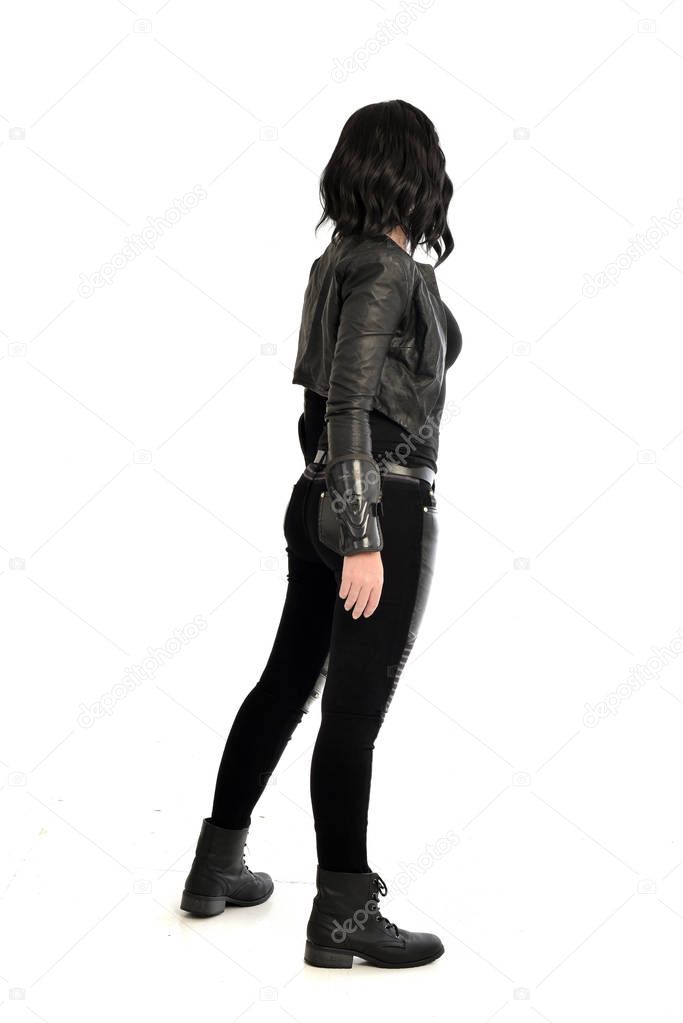 Retrato De Cuerpo Entero De Niña De Pelo Negro Con Traje De Cuero Mirando Hacia Fuera De La