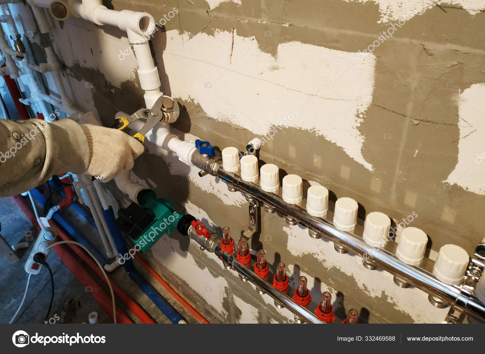 Installation of heating a new home, the worker connects the pipe to the ...