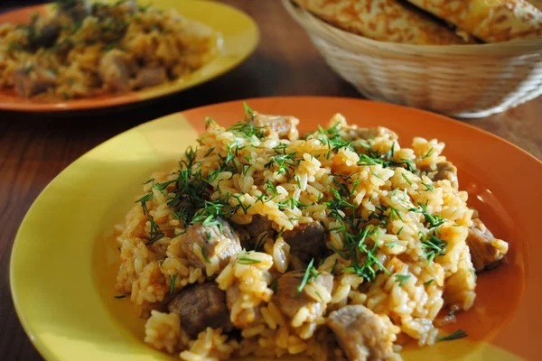 Rice with meat. Plov on the plate. Beef meat with rice. Dish on the ...