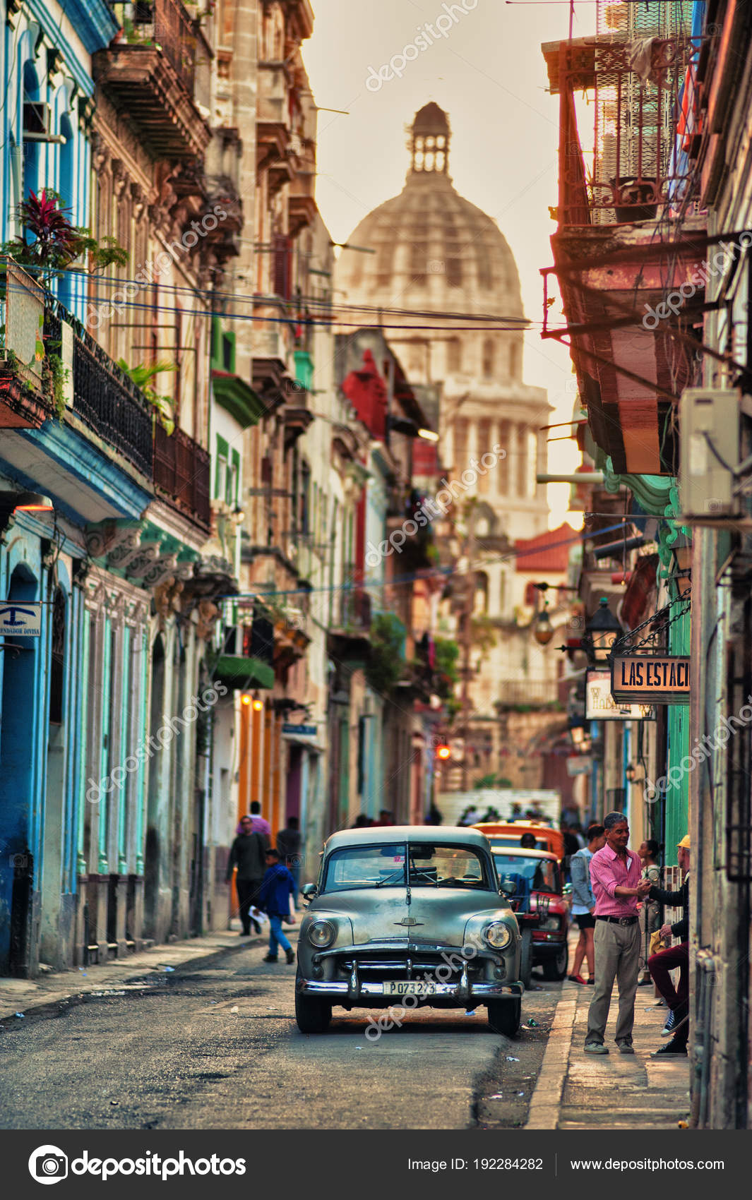 Typical vintage view of a street of old havana, cuba with peoples and ...