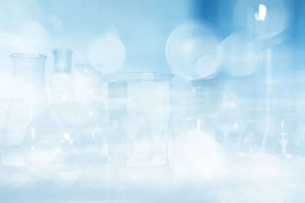 Laboratory vessels on table Stock Photo by ©TunedIn61 85073010