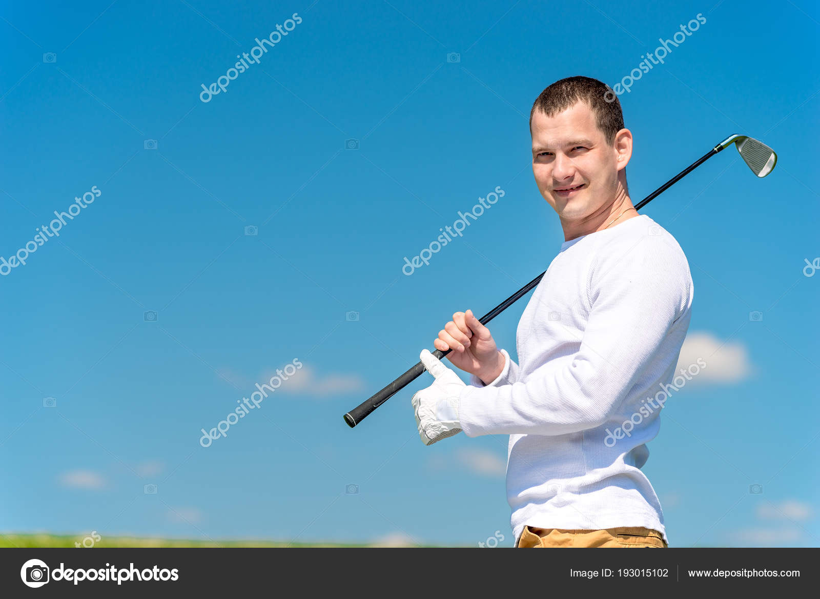 Horizontal portrait of a successful golfer with a golf club on t ...