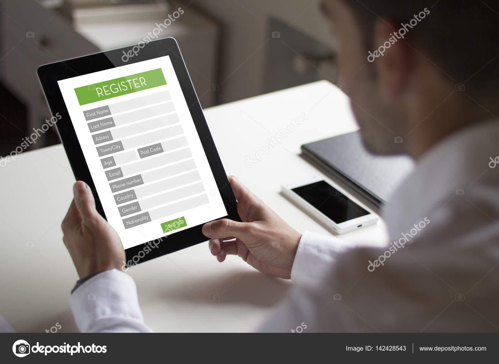 Businessman registering on web with tablet pc Stock Photo by ...