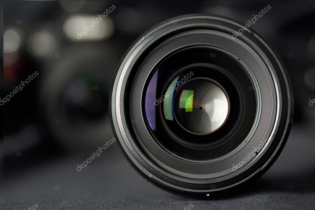 Photo lens front view on blurred camera — Stock Photo © ryzhov #128779856