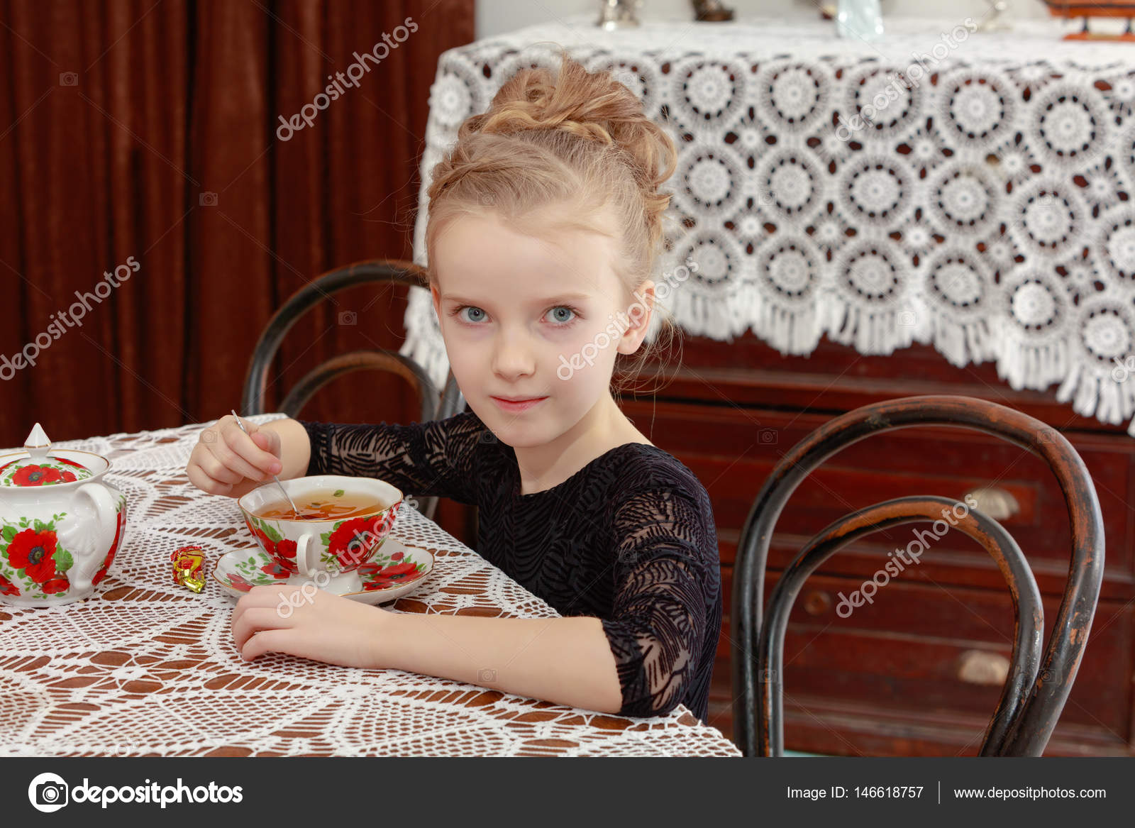 Beautiful little girl drinking tea at the table. Stock Photo by ...