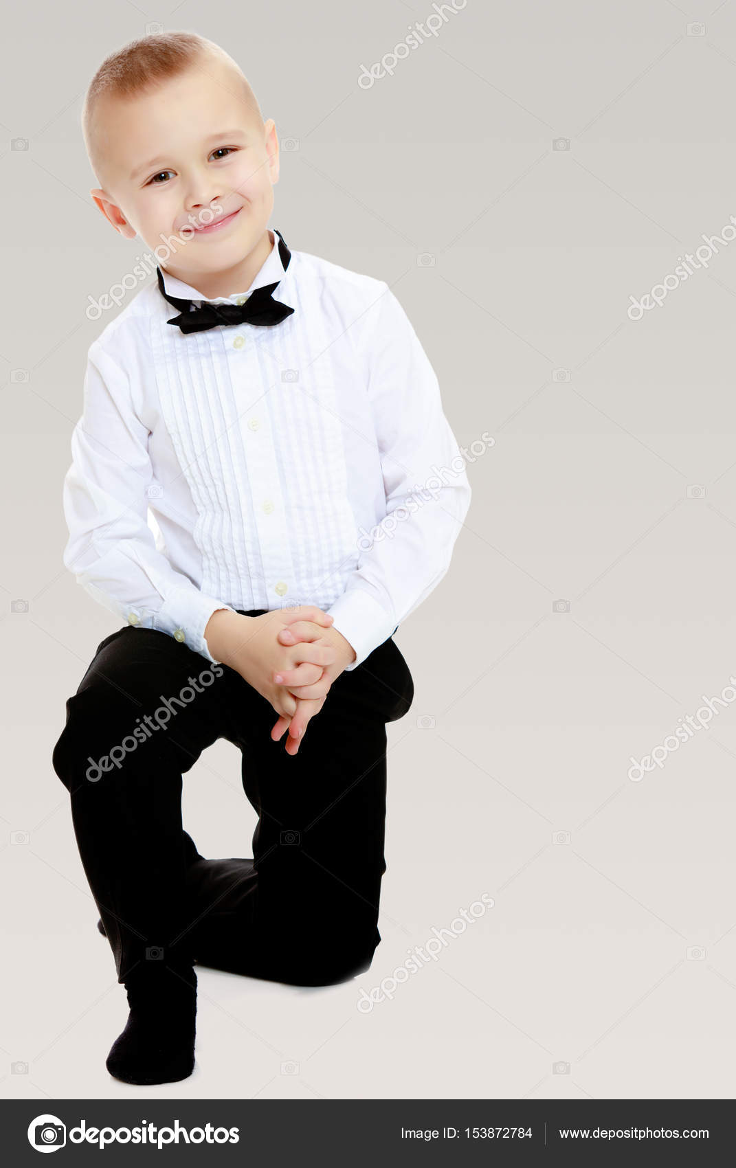 Little boy in a white shirt and tie. Stock Photo by ©lotosfoto1 153872784