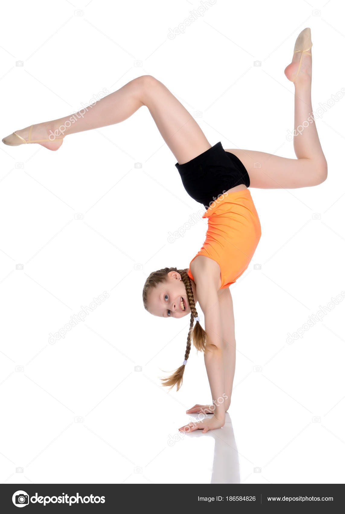 The gymnast performs a handstand with bent legs. Stock Photo by ...