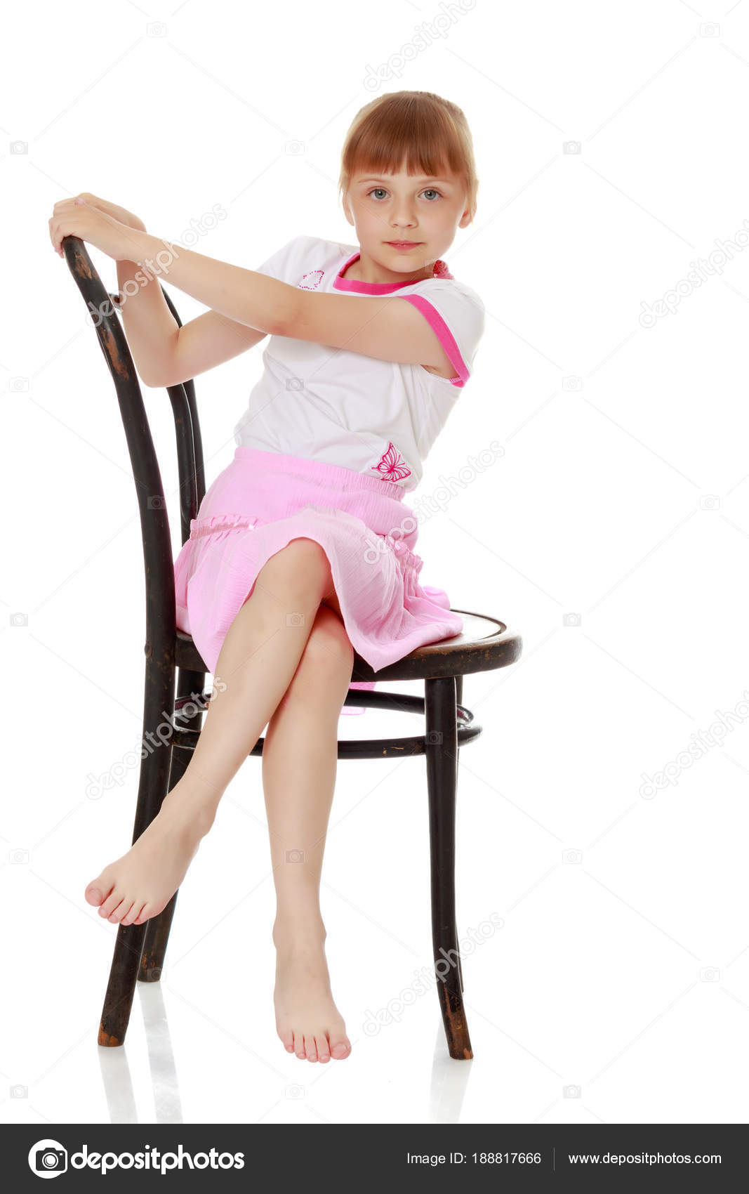 Little girl is sitting on a chair — Stock Photo © lotosfoto1 #188817666