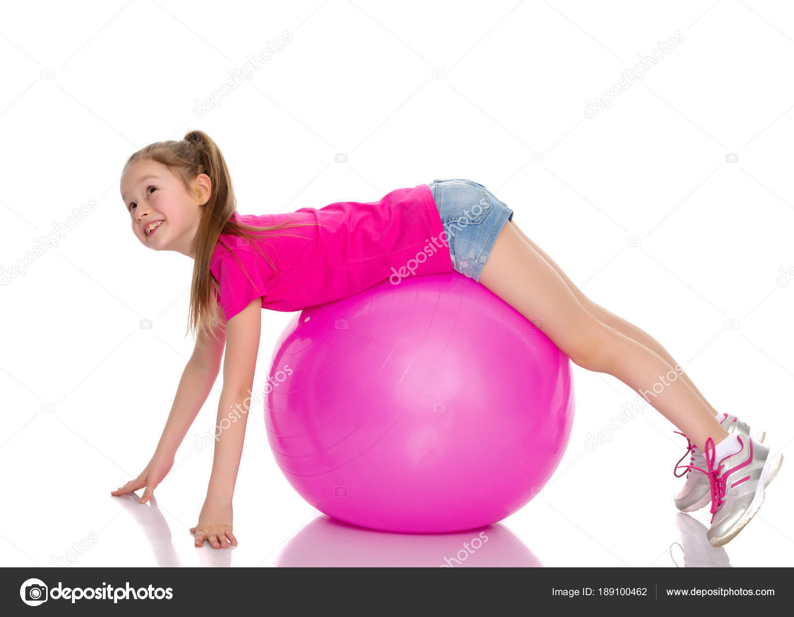 Little girl doing exercises on a big ball for fitness. Stock Photo by ...