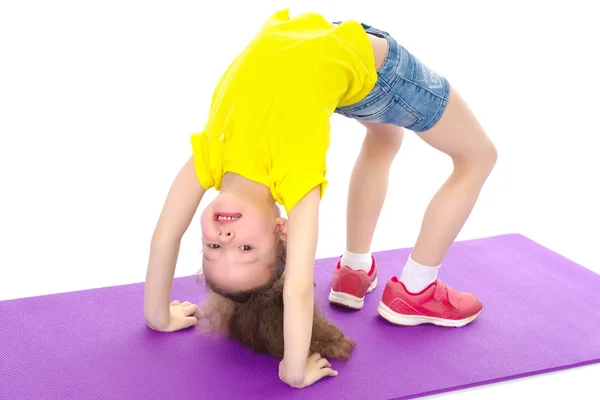 Flexible contortionist kid girl playing on white — Stock Photo ...
