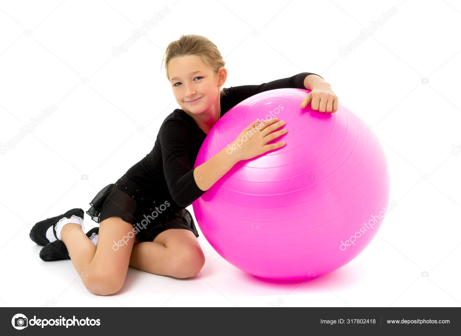 Little girl doing exercises on a big ball for fitness. Stock Photo by ...