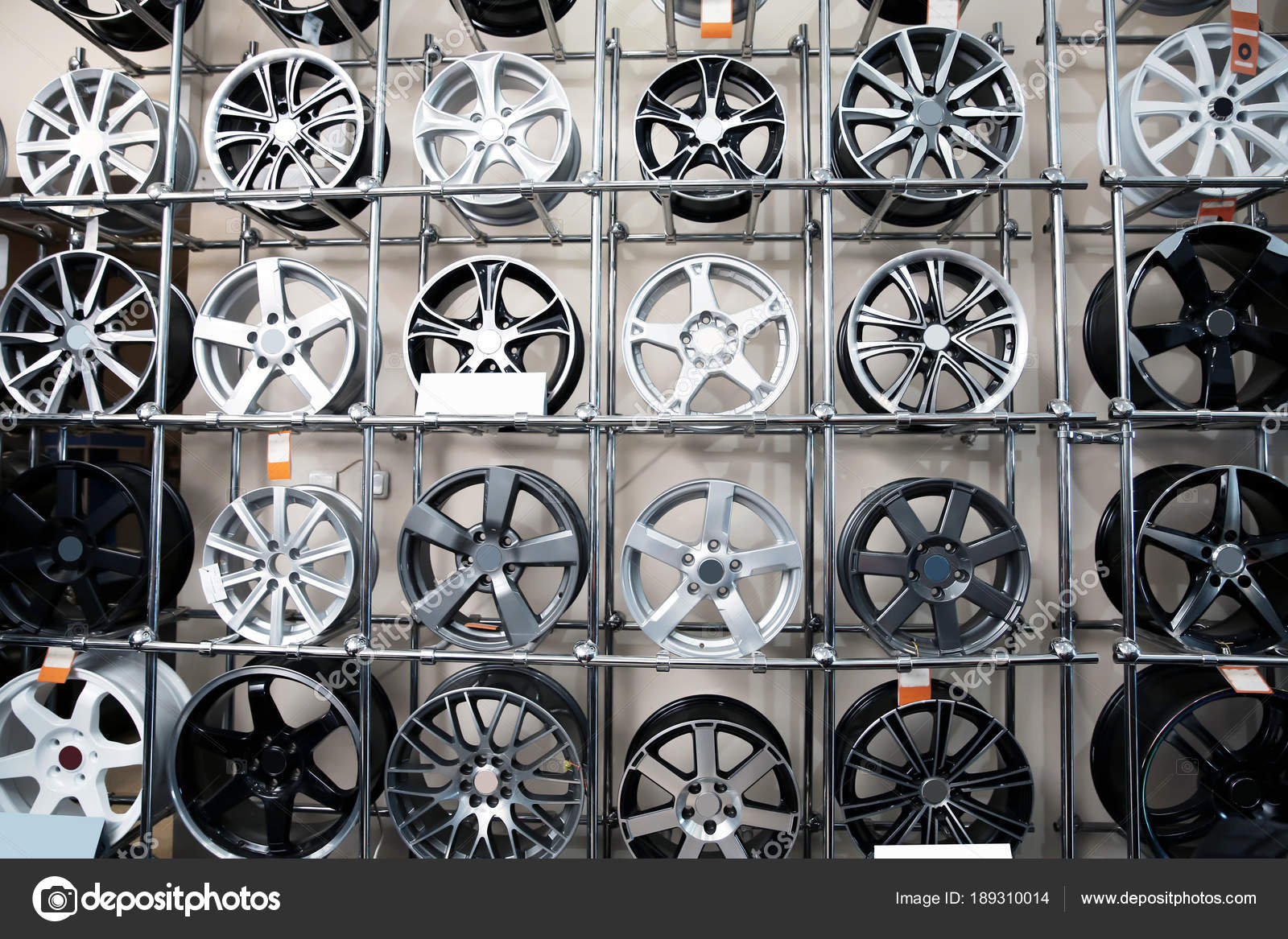 Alloy wheels on racks in automobile service center Stock Photo by ...