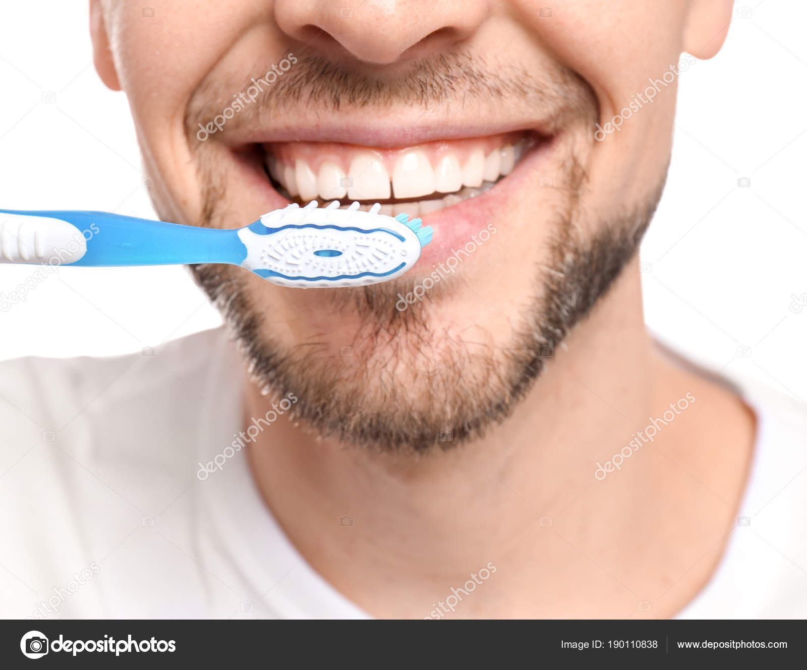 Young man brushing his teeth on white background Stock Photo by ...