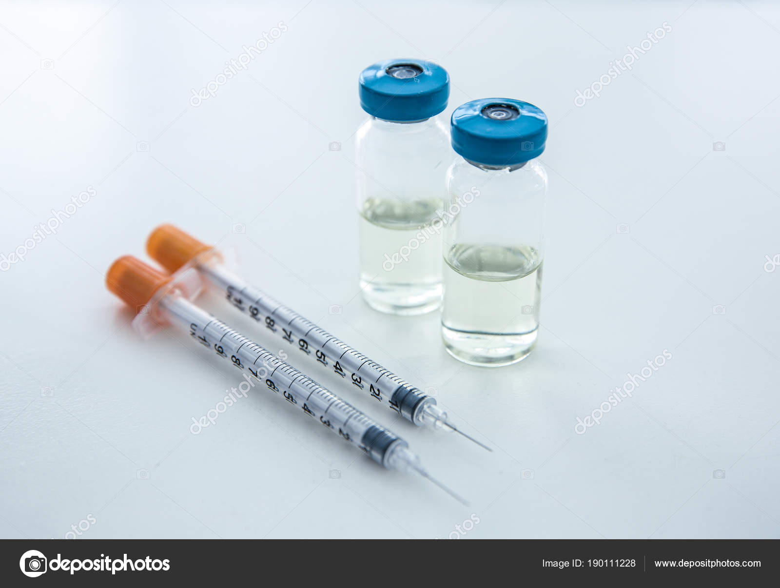 Vials with medicine and syringes on light background. Vaccination ...